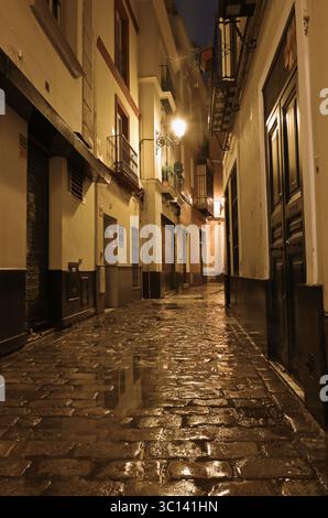 Narrow street in Seville at night, Spain Stock Photo - Alamy