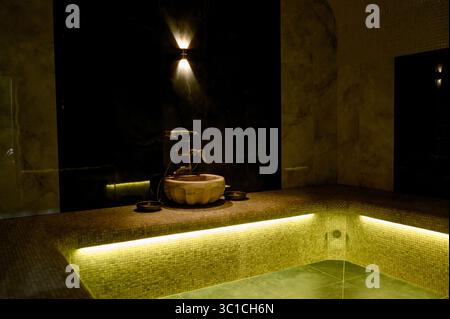 Interior of a hammam sauna with stone finishing and lighting. Spa or ...