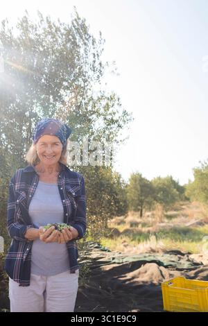 Smiling woman in bandana holding pineapple isolated on blue Stock Photo ...
