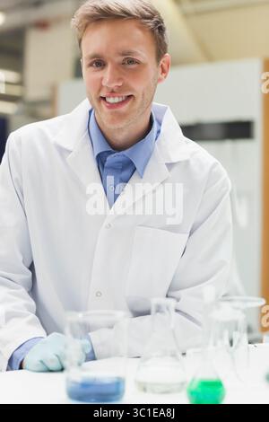 Holding chemical glass. Chemical scientist wearing headscarf holding ...