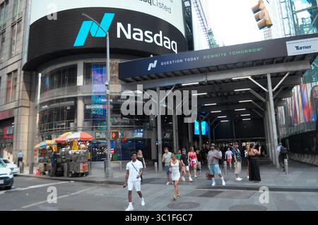 People walk past the Nasdaq MarketSite Times Square event space in ...