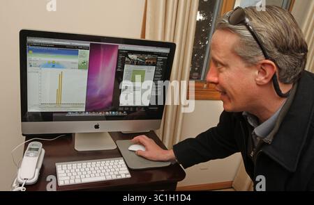 Image of two computer monitors installing the new software in dark ...
