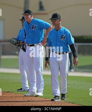 Miami Marlins' Garrett Cooper, left, high-fives before a baseball game ...