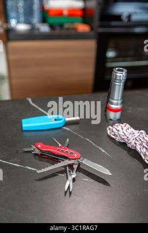 Emergency supplies on kitchen counter with lantern, rope and multitool ...