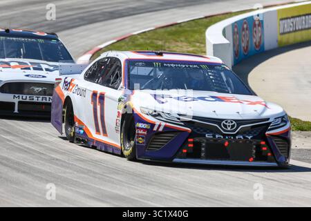 Denny Hamlin drives during a NASCAR Cup Series auto race at Pocono ...