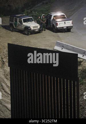 U.S. Border Patrol agents stand at attention alongside Alejandro ...
