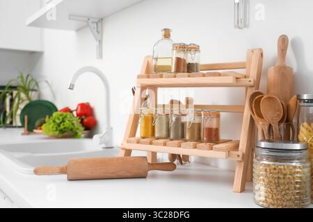 Stand with different spices on counter in kitchen, closeup Stock Photo ...