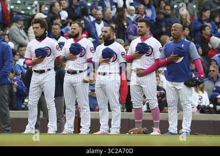 Milwaukee Brewers players stand for the national anthem before a ...