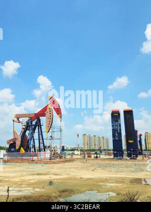Oil Pumpjacks and Urban Skyline at Sinopec Shengli Oilfield, Dongying ...