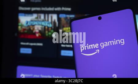 Smartphone displaying Prime Gaming logo with gaming interface in the ...