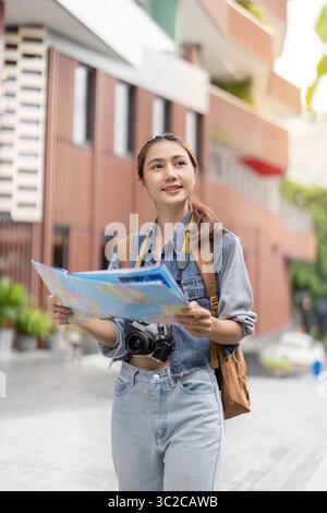Happy young woman with a city map on bike in european city Stock Photo ...