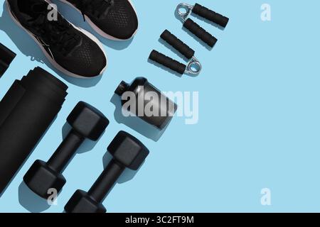 Hand grip strengthener on a flat surface with workout gear Stock Photo ...