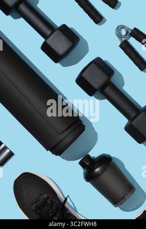 Hand grip strengthener on a flat surface with workout gear Stock Photo ...