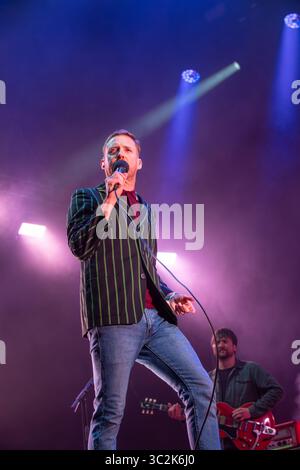 Ricky Wilson, lead singer of the Kaiser Chiefs singing into microphone ...