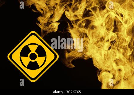 Radioactive sign and yellow toxic smoke against black background Stock ...