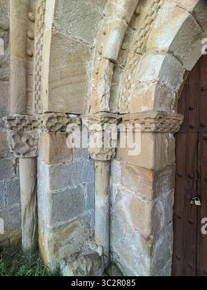 Romanesque decorations carved in the stone wall of an ancient medieval ...