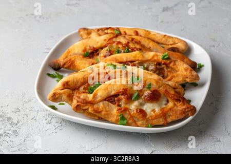 Dishes from traditional Turkish cuisine; Mini pita with minced meat ...