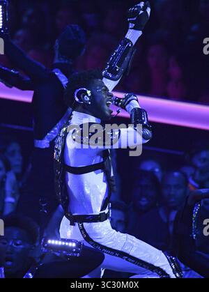 Lil Nas X, center, performs during the 2021 Jingle Ball at The Forum ...