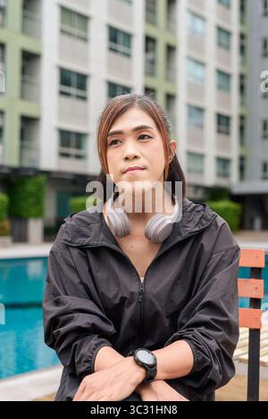 Mature transgender woman enjoying outdoor relaxation by the pool in ...