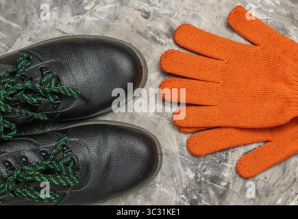Leather safety boots on concrete background Stock Photo - Alamy