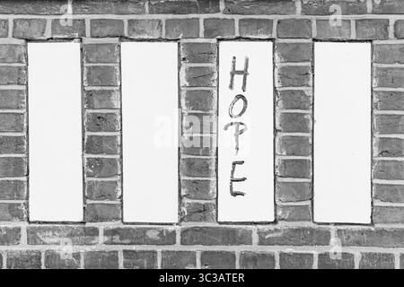 The word “HOPE” is hand-painted in vertical orientation on a cream ...