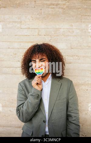 Confident transgender professional stands in modern office, arms ...