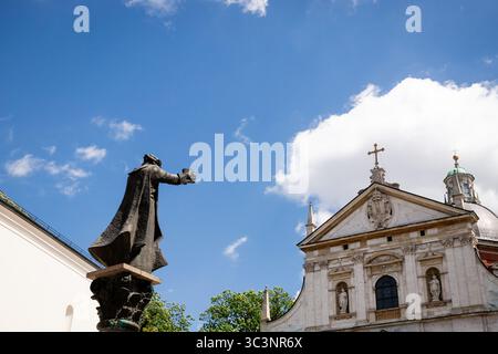 Monument of Piotr Skarga and a Baroque facade of Church of Saints Peter ...