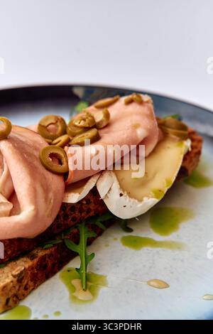 Appetizing slice of bread with creamy cheese spread on rustic wooden ...