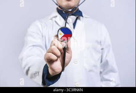 Doctor holding stethoscope with Philippines flag. Philippines health ...