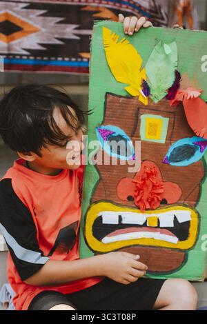 A playful boy displays a unique expression, showcasing his curiosity ...