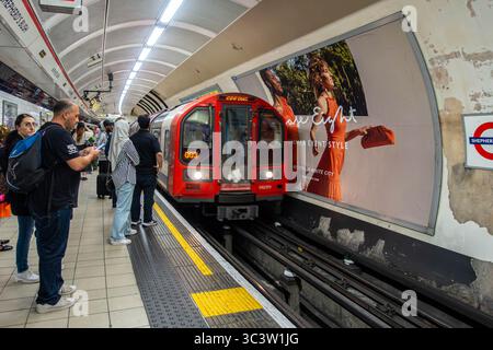 A London Underground train arrives into Shepherds Bush tube station on ...