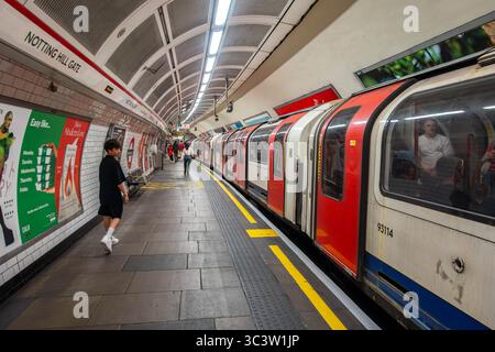 A train departs from Notting Hill Gate London Underground Station on ...