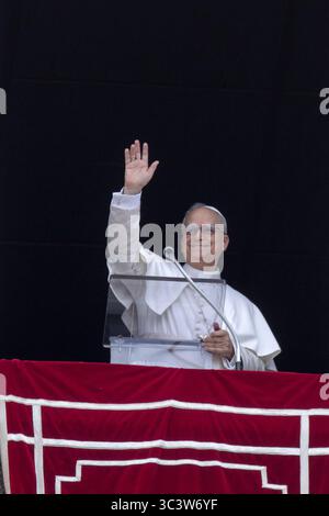 Pope Leo XIV waves during the Angelus noon prayer from the window of ...