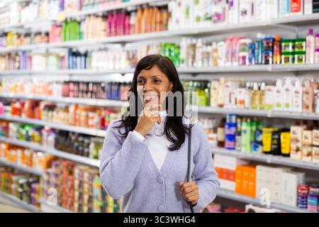 Interested in my hair and my hairdresser. Happy girl hold hair braids ...