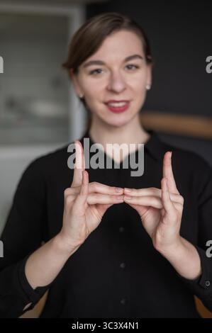 Woman showing the words hostel and bed in sign language Stock Photo - Alamy
