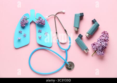 Asthma inhalers with paper lungs, stethoscope and lilac flowers on pink ...