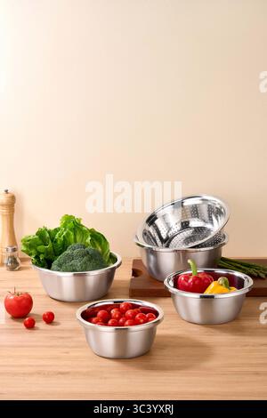 Colander with different kitchen utensils on wooden background Stock ...