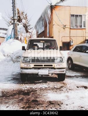 A scenic view of icicles hanging on a wooden branch in a forest in ...