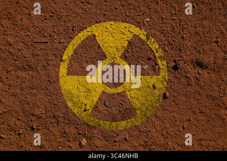 Radioactive sign on brown ground with shoes track, top view ...