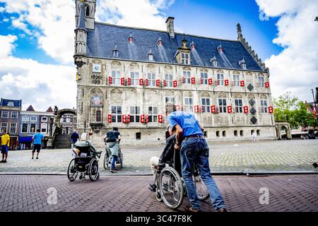 GOUDA - Walking on the street with a person in a wheelchair ROBIN ...