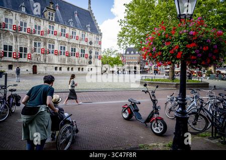 GOUDA - Walking on the street with a person in a wheelchair ROBIN ...