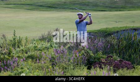 Bryson DeChambeau hits out of the rough on the seventh hole during the ...