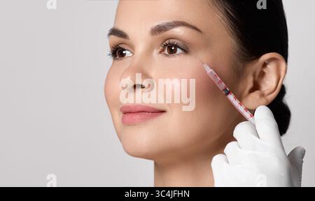 Beautiful woman receives anti wrinkle beauty injection for facial ...