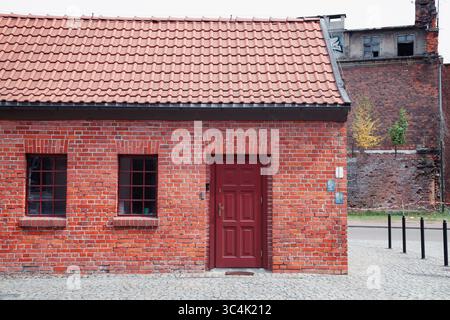 Brick industrial building utility service bay with two large brown ...