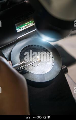 Diamond grading to assess clarity, cut, and quality in a factory in ...