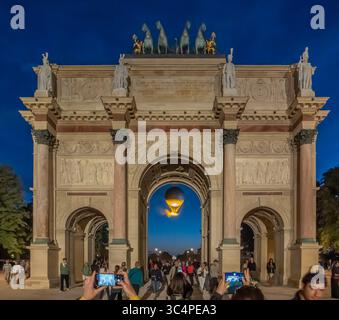 Paris, France - 07 28 2025: People standing are walking under Carrousel ...