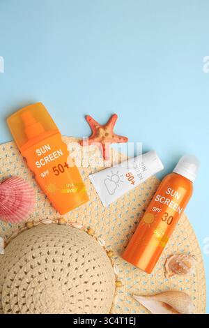 Sunscreens and starfish on blue background, top view Stock Photo - Alamy