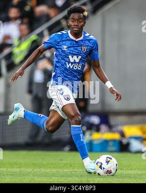 Simon Adingra of Sunderland breaks with the ball under pressure from ...