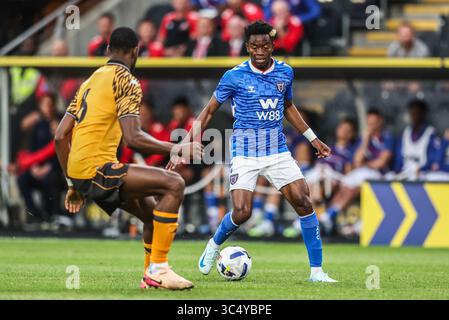 Simon Adingra of Sunderland breaks with the ball under pressure from ...