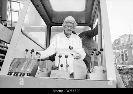 A hard hat sits on a control panel in an empty production line within a ...
